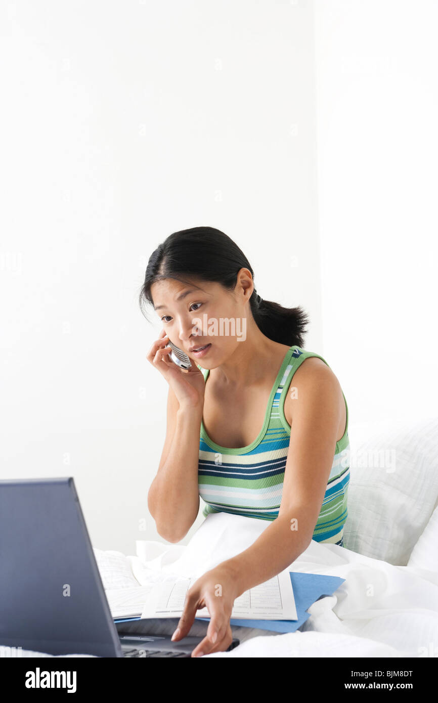Female working from bed Stock Photo - Alamy