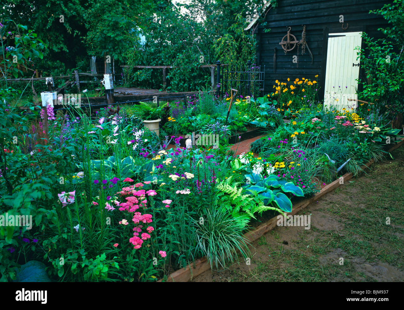 A waterside garden growing flowers and vegetables in summer Stock Photo ...