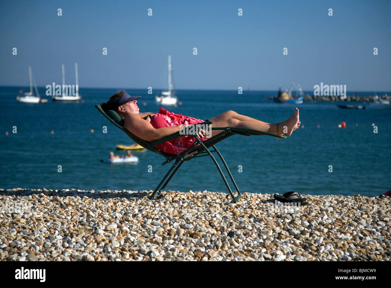 a woman sunbathing on a beach in england Stock Photo - Alamy
