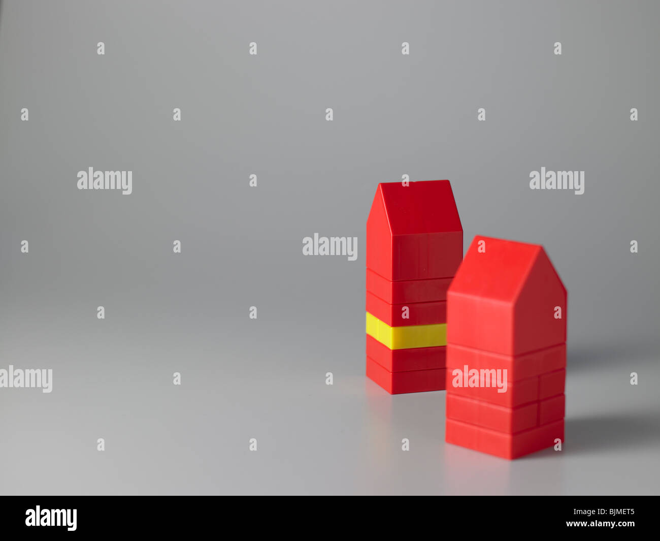 Toy blocks in housing shapes depicting the odd one out. yellow odd ...