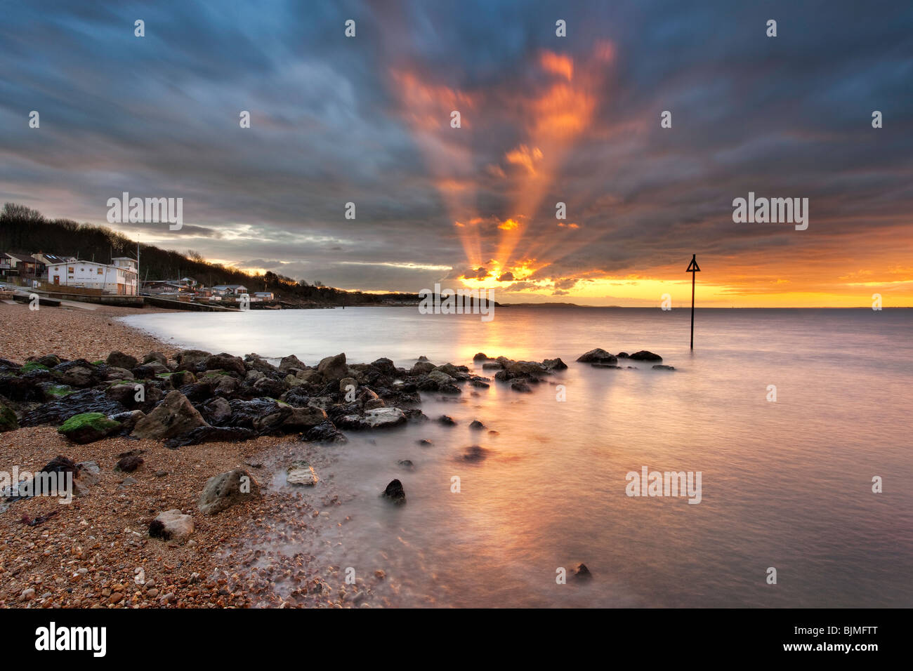 Sun setting over Gurnard Bay. Isle of Wight, England, UK Stock Photo ...