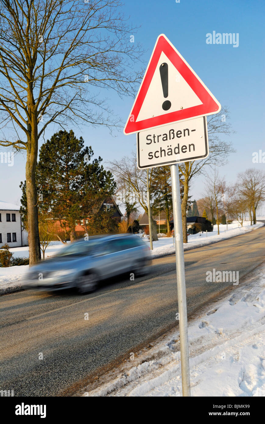 Hard winter, traffic sign "Strassenschaeden" road damage Stock Photo ...