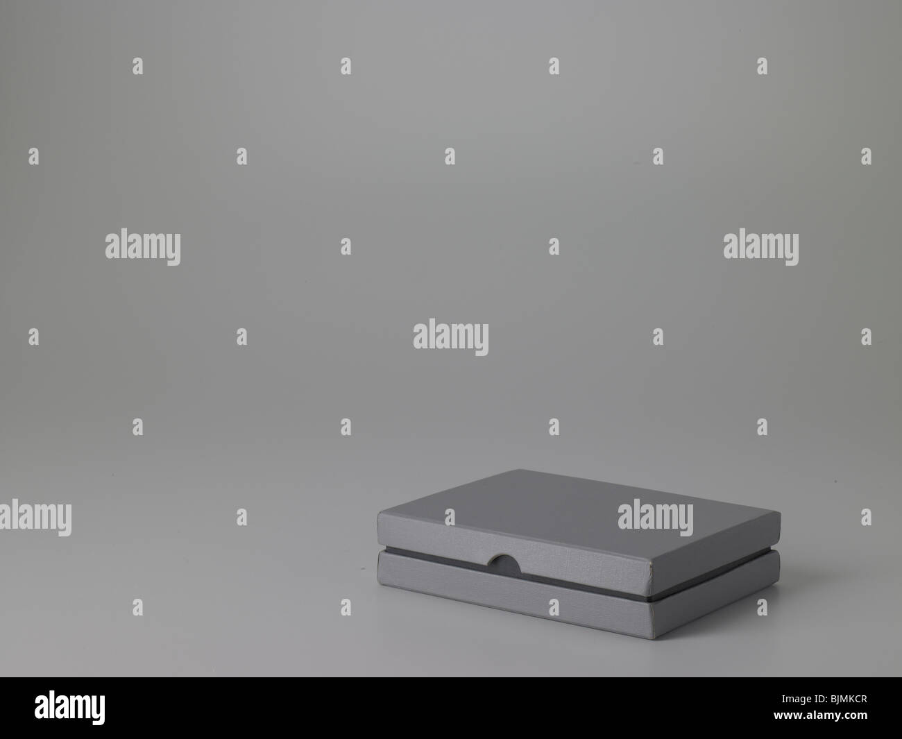 Grey box on grey background with lid on Stock Photo - Alamy