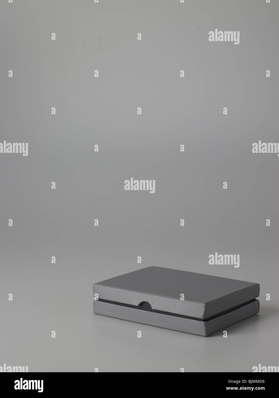 Grey box on grey background with lid on shot in portrait format Stock ...