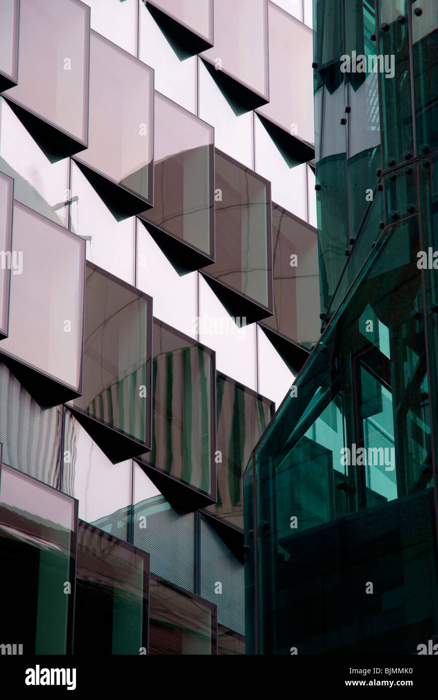 Pattern of windows forming wedges on a modern high rise building Stock ...