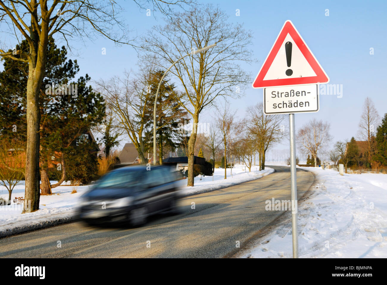 Hard winter, traffic sign "Strassenschaeden" road damage Stock Photo ...