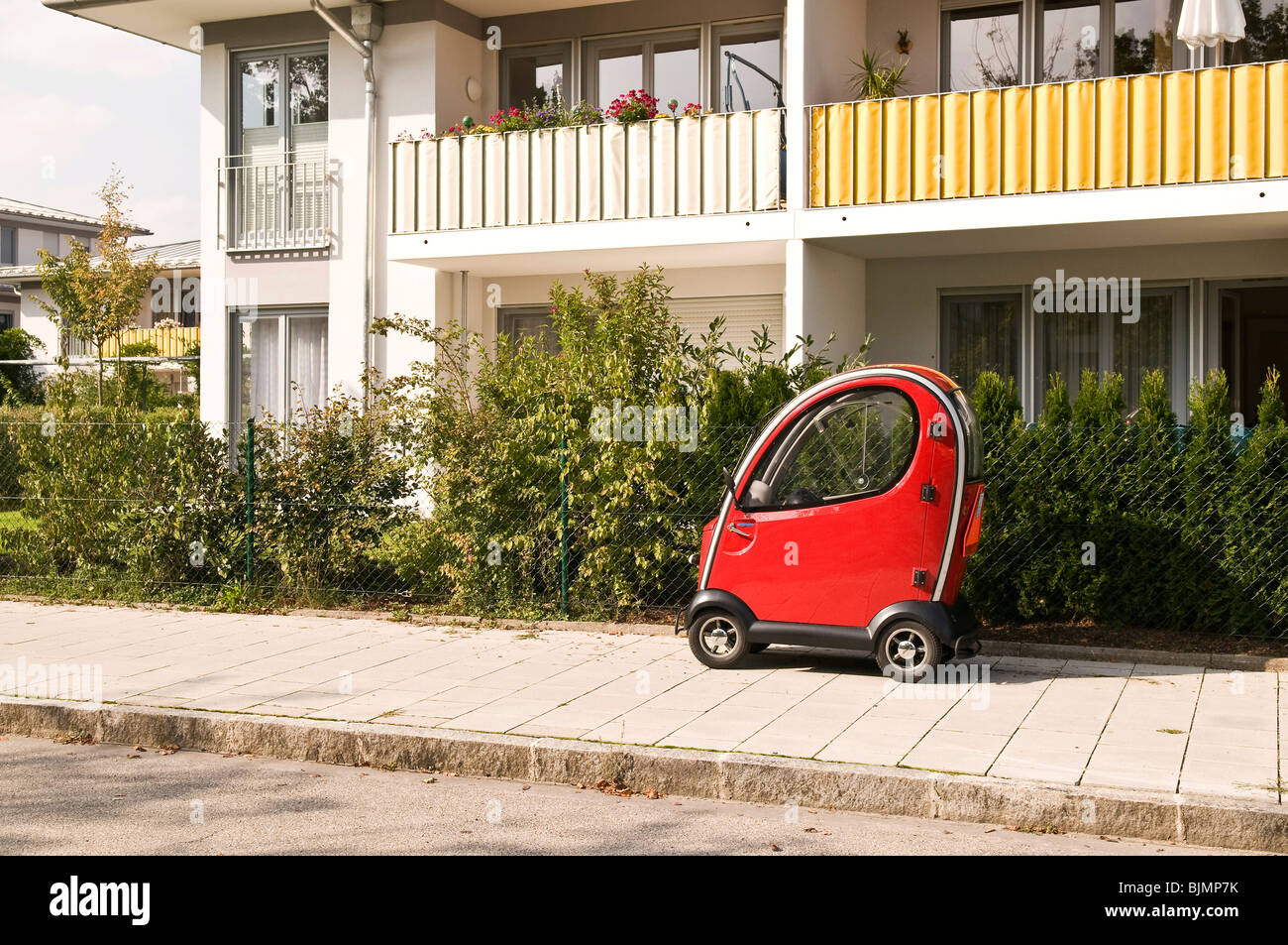 Red mini car in front of a modern house, Munich, Bavaria, Germany ...