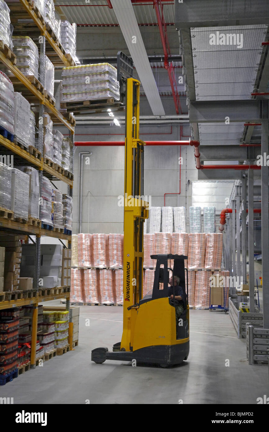 Hamm: warehouseman operating forklift in a high rack warehouse of ...