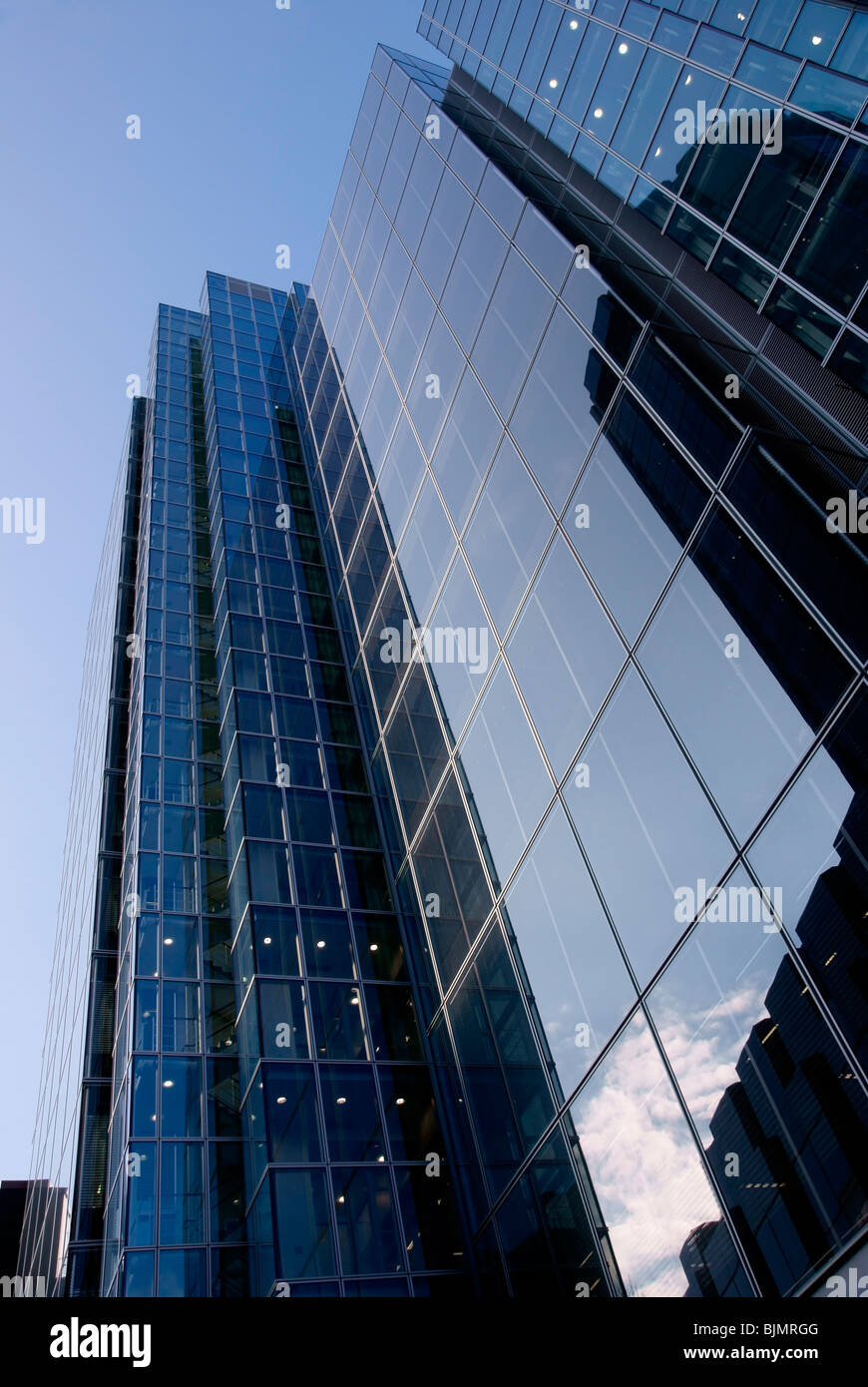 Reflected buildings in glass cladding Stock Photo - Alamy