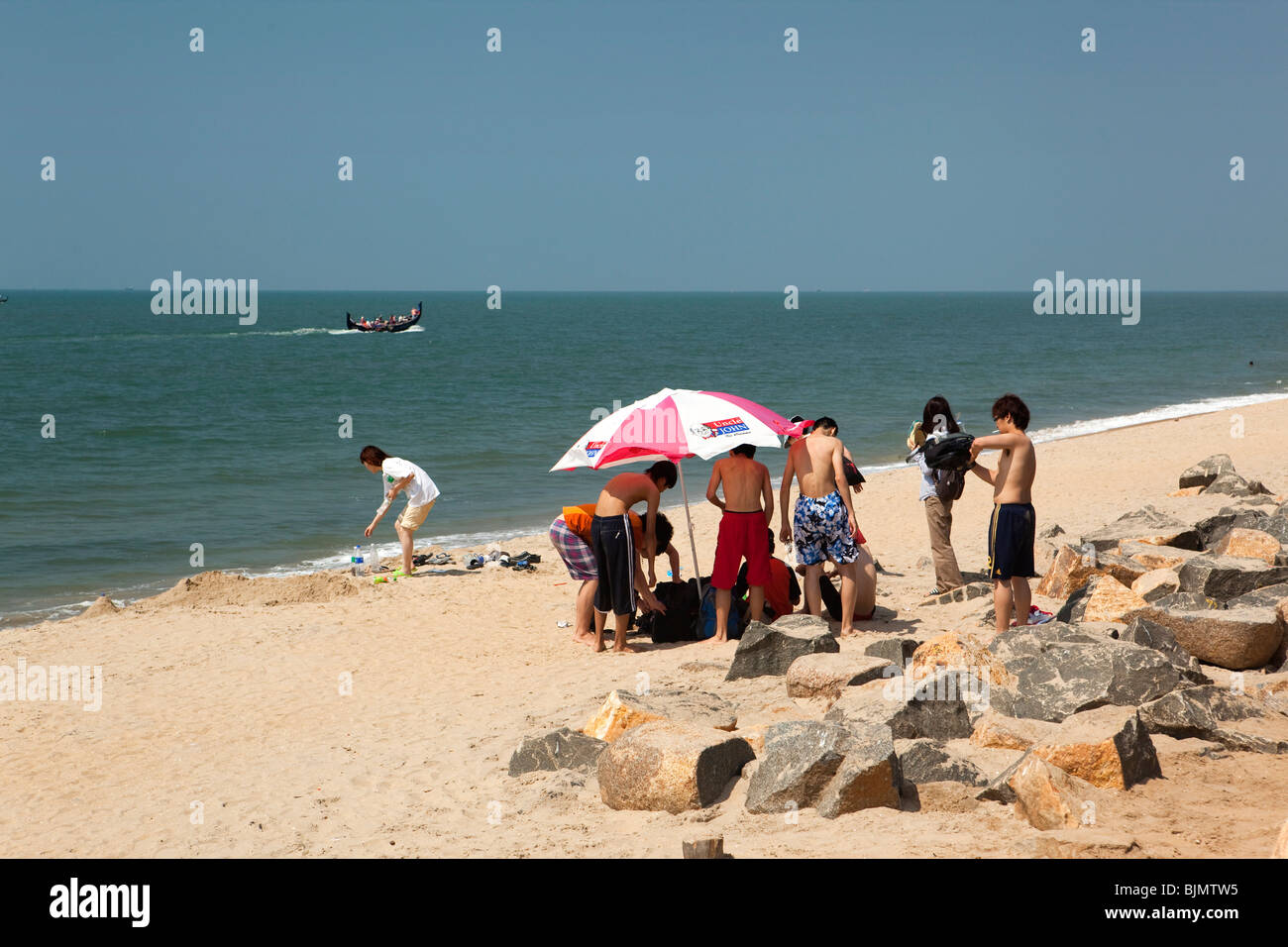 India, Kerala, Vypeen Island, Cherai Beach western tourists in shade of ...