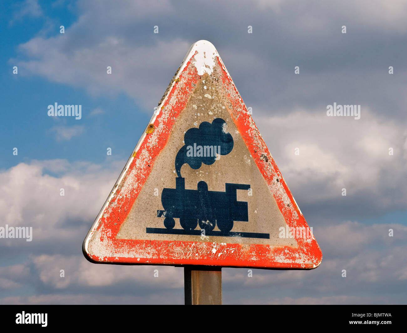 Old, faded road traffic sign indicating railway crossing - Indre-et ...