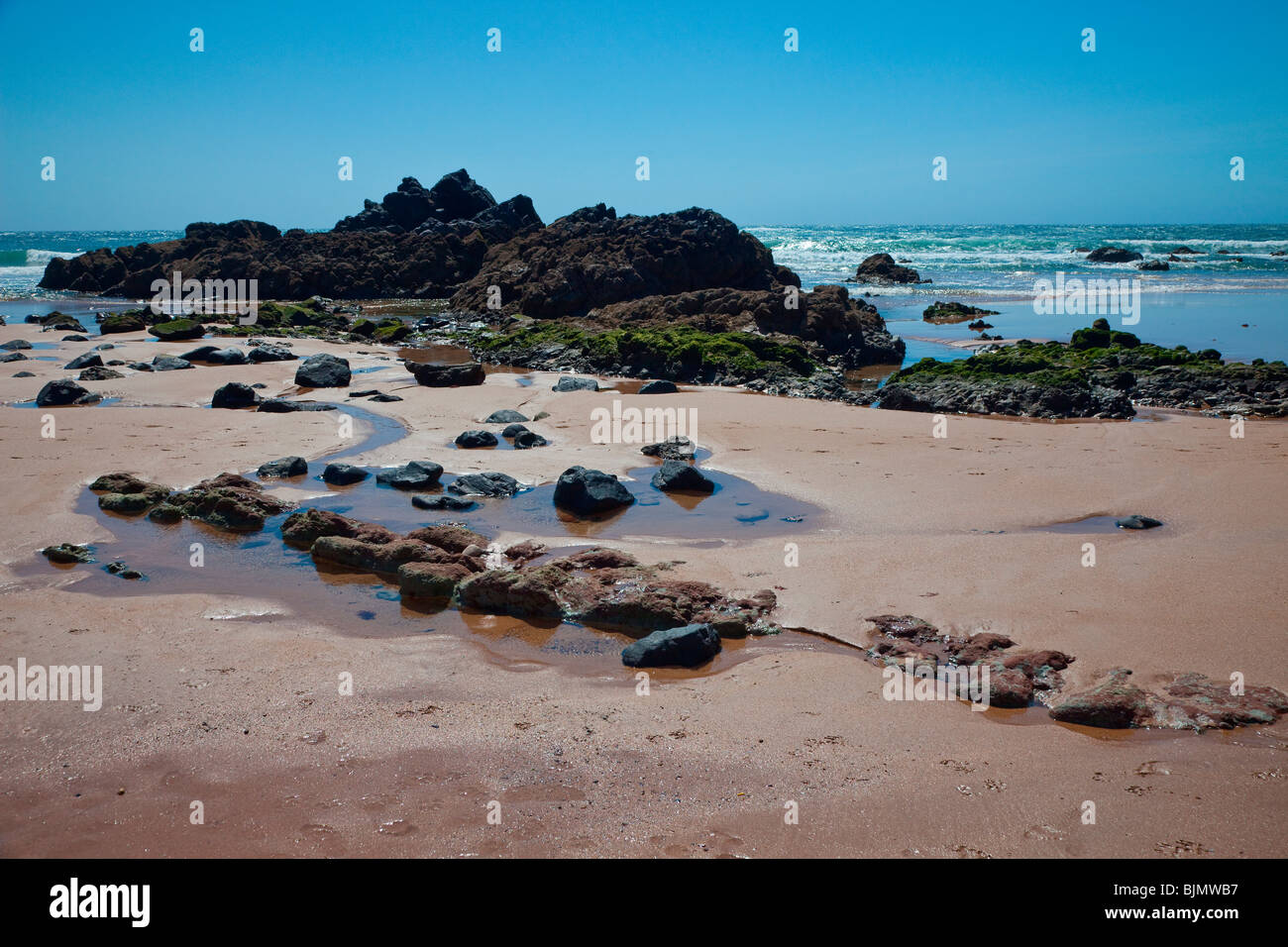 Rocks and stones on the beach against the blue sea on the coast of the ...