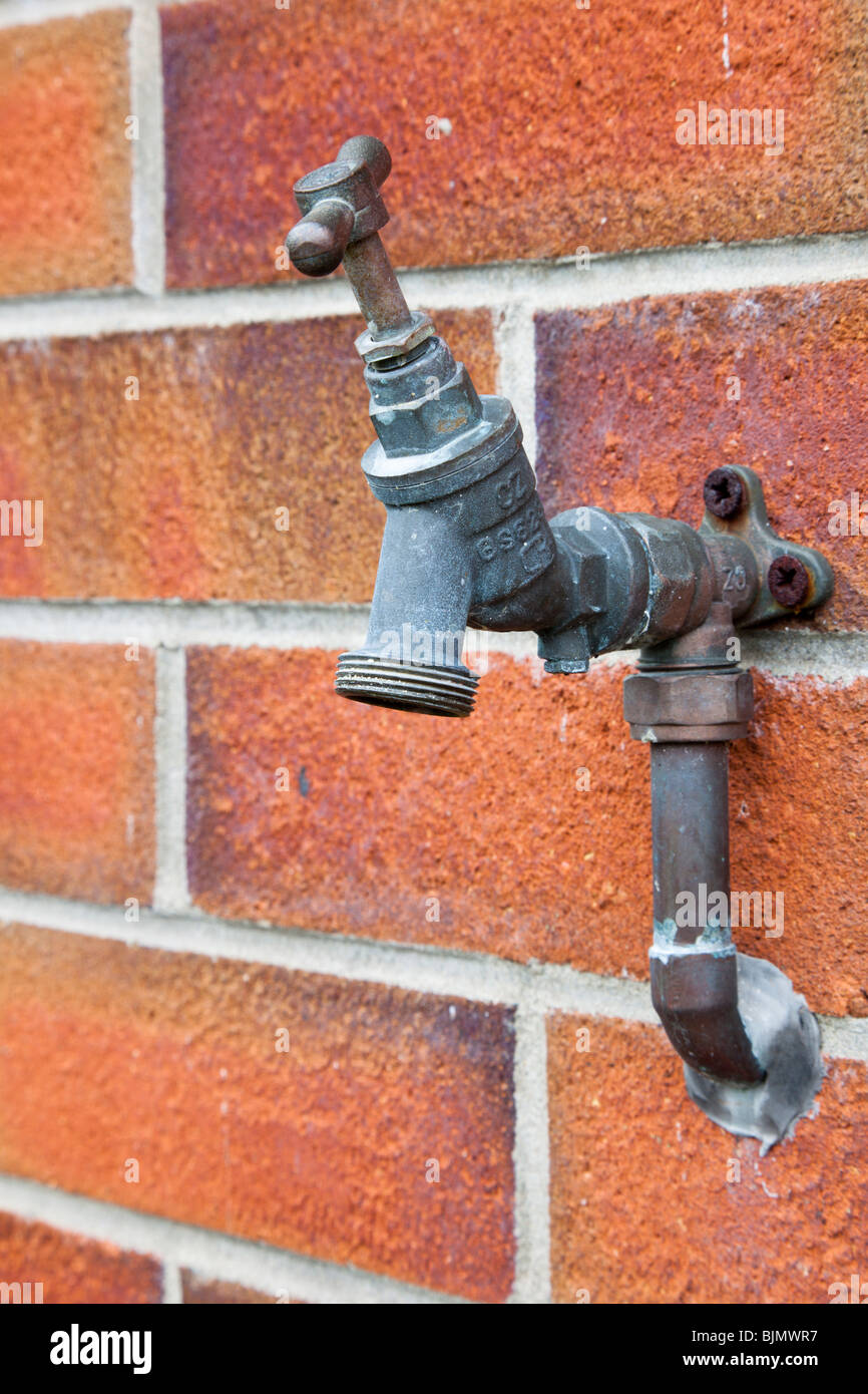 Outside tap switched off and fixed to a brick wall Stock Photo - Alamy