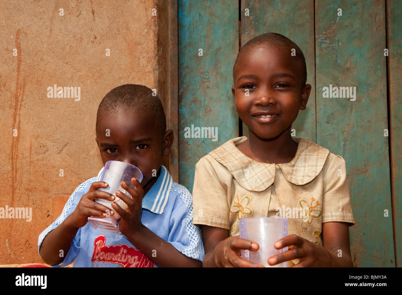 Children enjoying a drink of fresh milk. Rwanda Stock Photo - Alamy