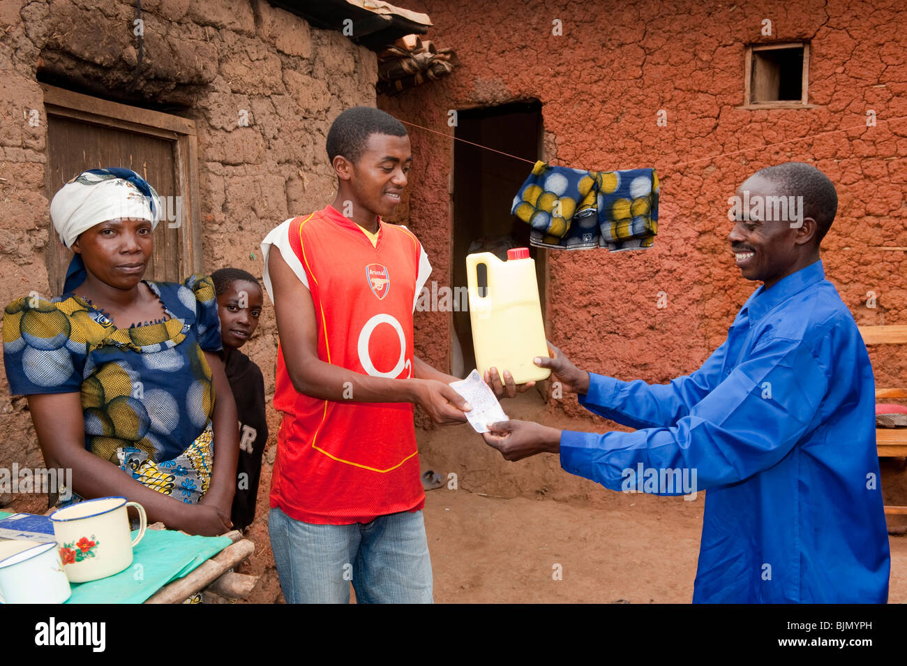 Farmer Selling Milk To Customer In Rural Village Near Kigali Rwanda