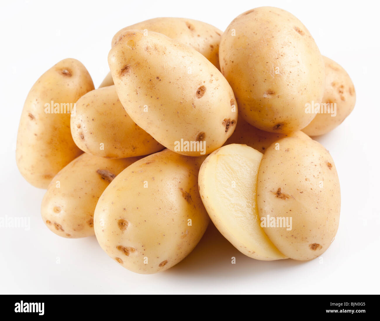 Yellow potatoes with segments on a white background Stock Photo - Alamy