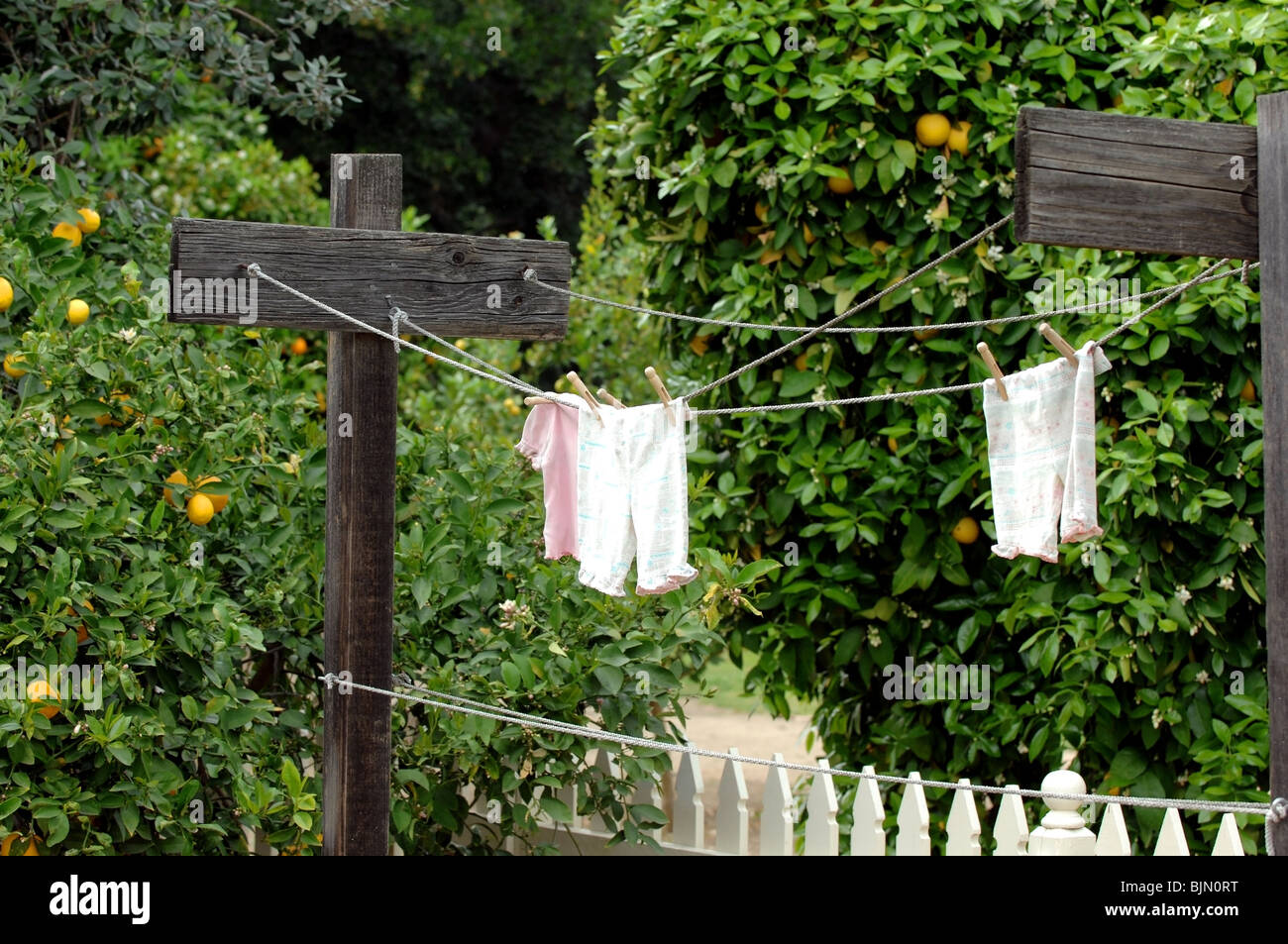 Vintage children's clothing drying on a clothes line with held with ...