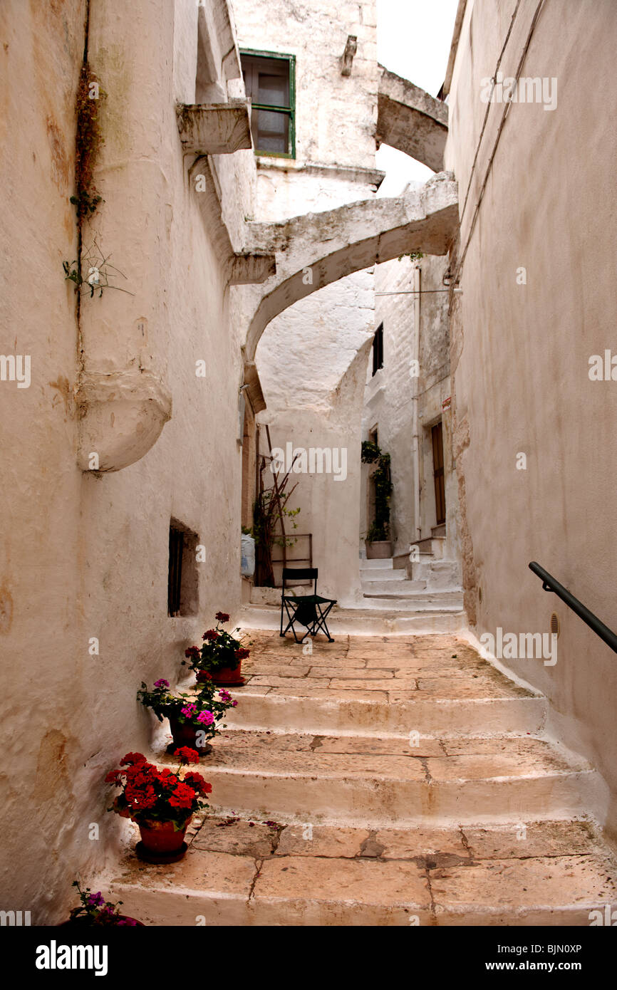 The alleys and narrow streets of the white city of Ostuni, Puglia ...