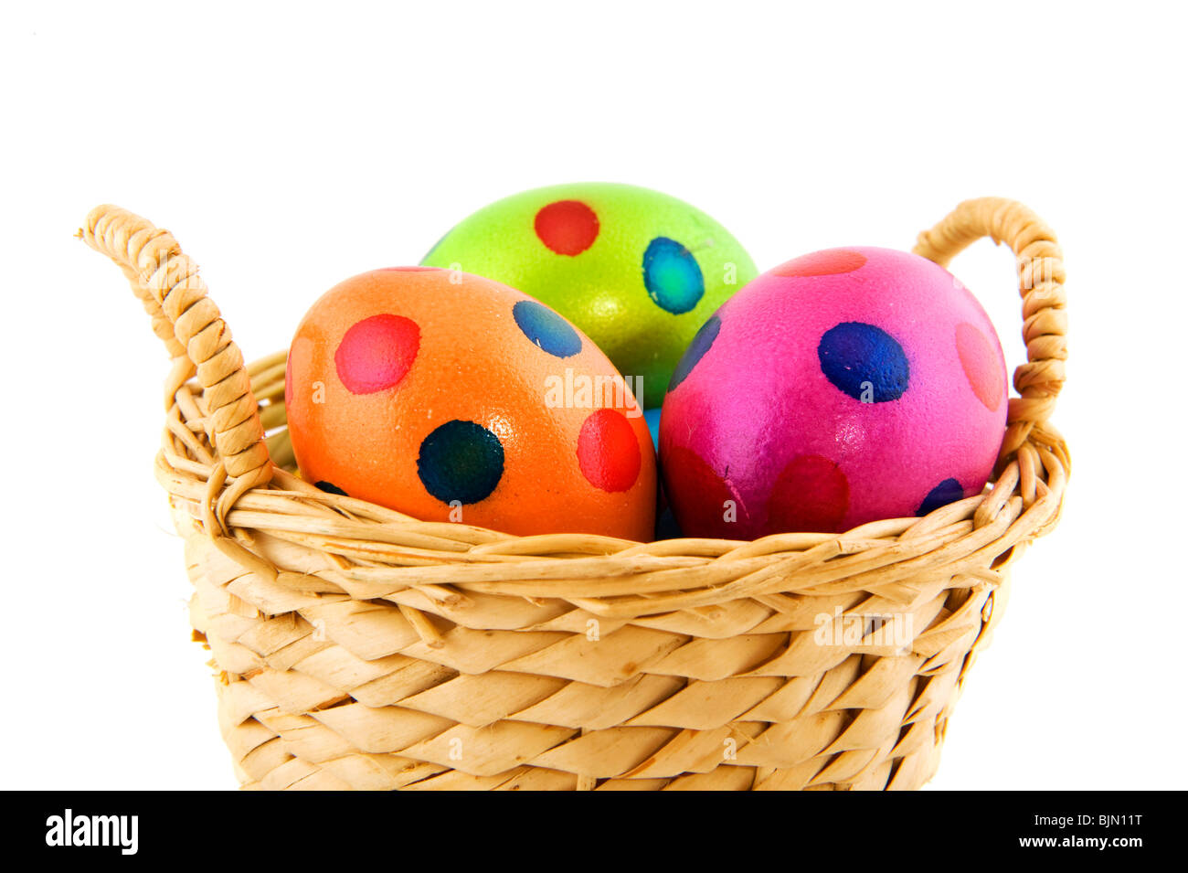 Basket filled with colorful spotted easter eggs Stock Photo - Alamy
