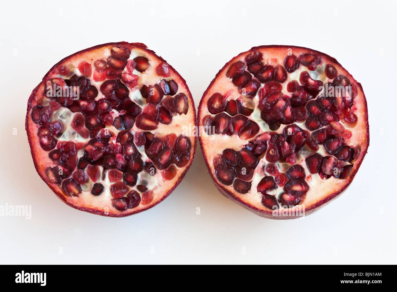 Cut half pomegranate cross section hi-res stock photography and images ...