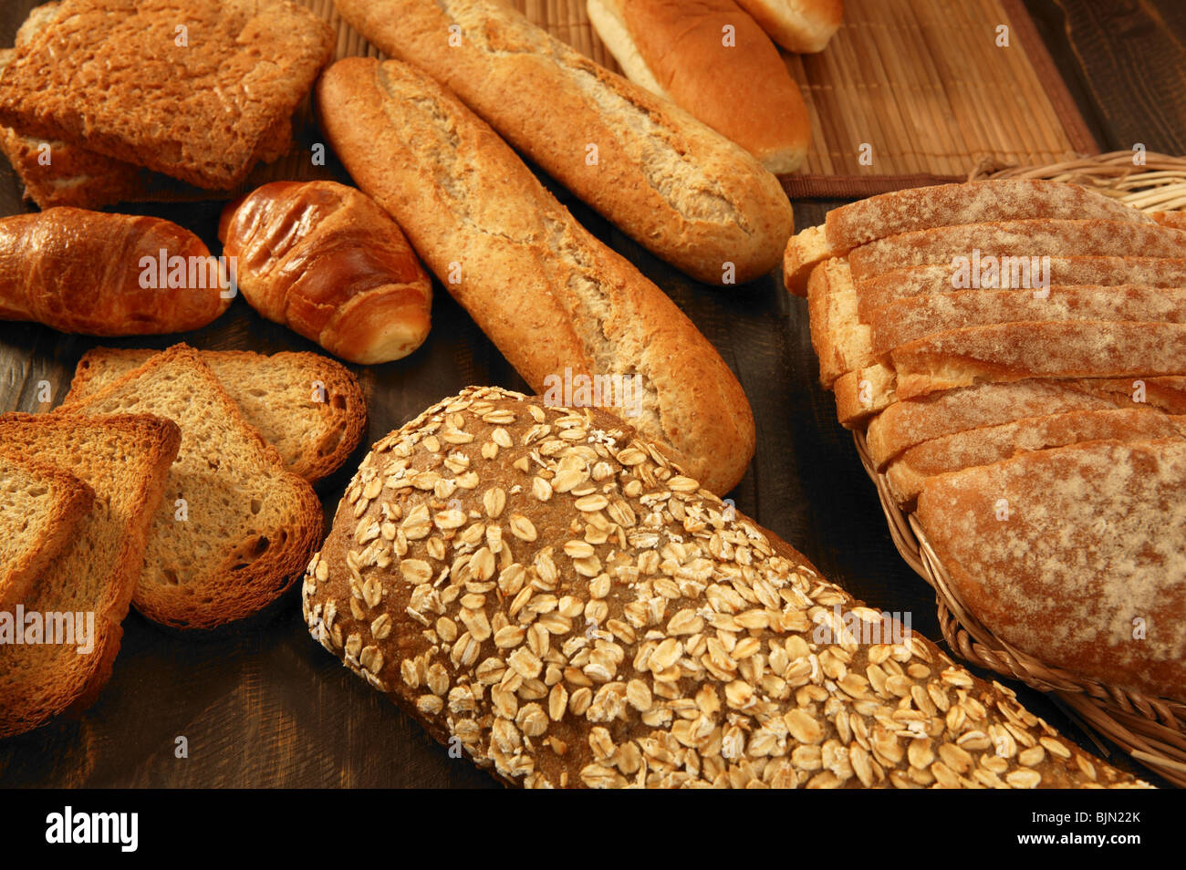 Varied bread still life over dark wood background Stock Photo - Alamy