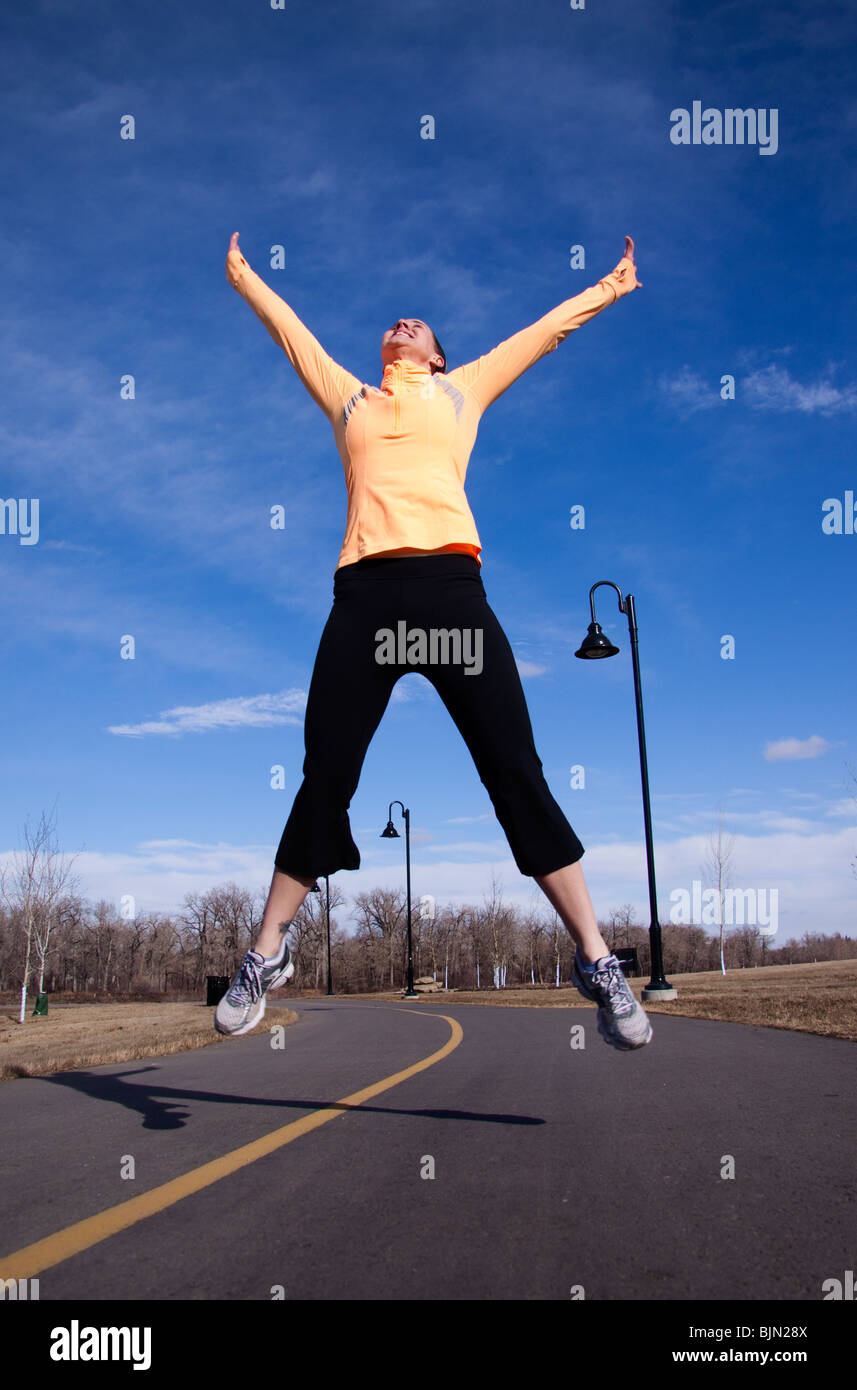 Woman young with open arms running hi-res stock photography and images ...