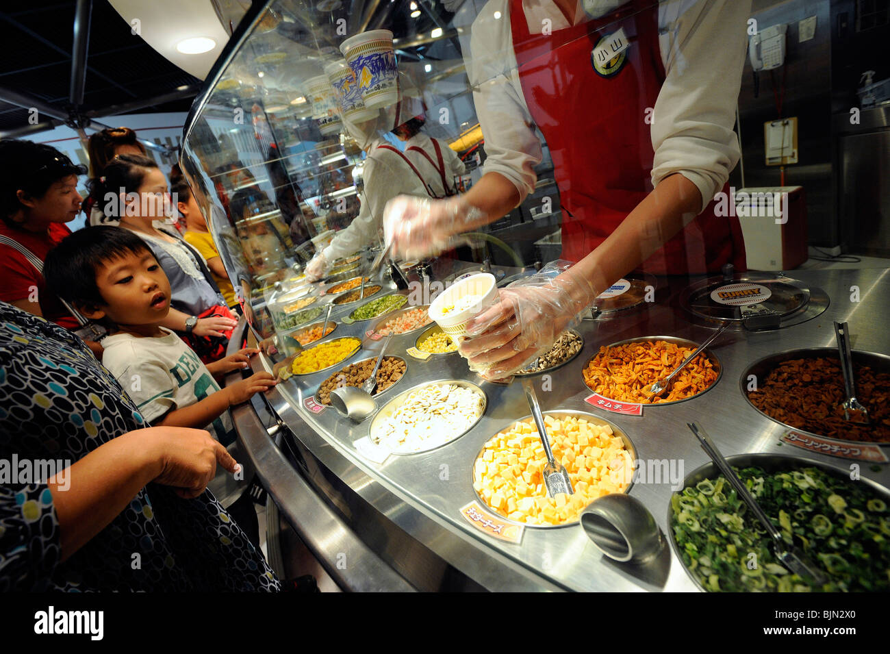 Visitors order toppings for their own original cup noodle inside the ...