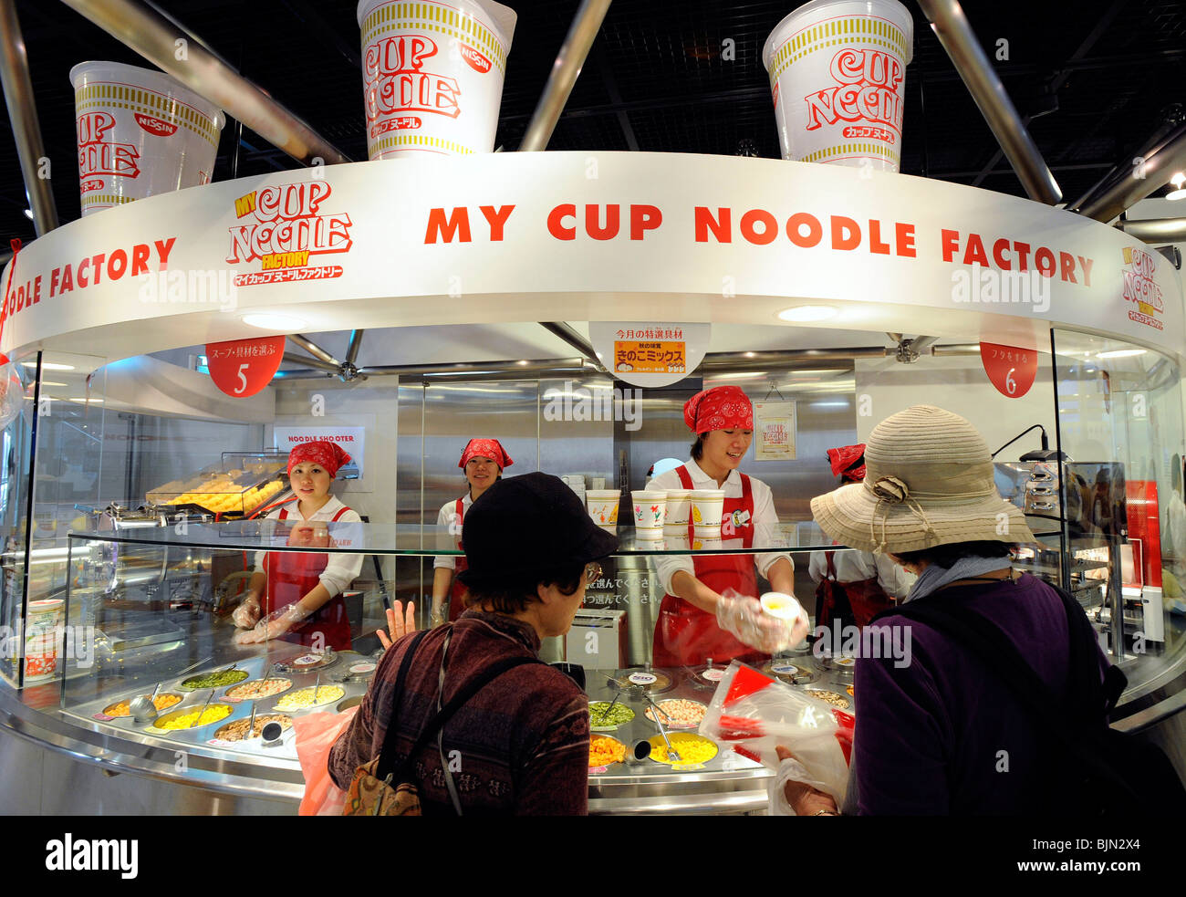 Visitors order toppings for their original cup noodles inside cup ...