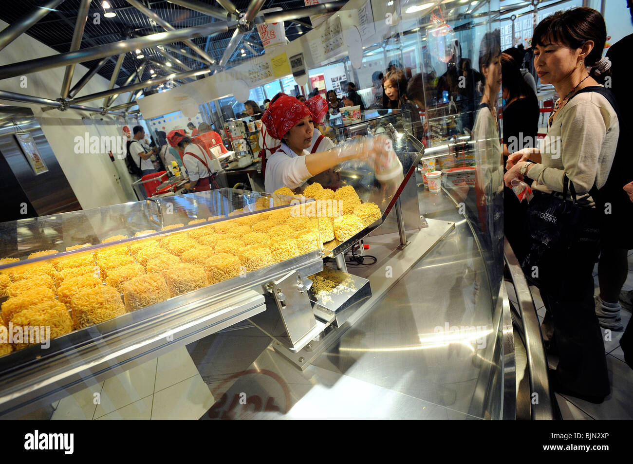 Visitors order toppings for their own original cup noodle inside the ...