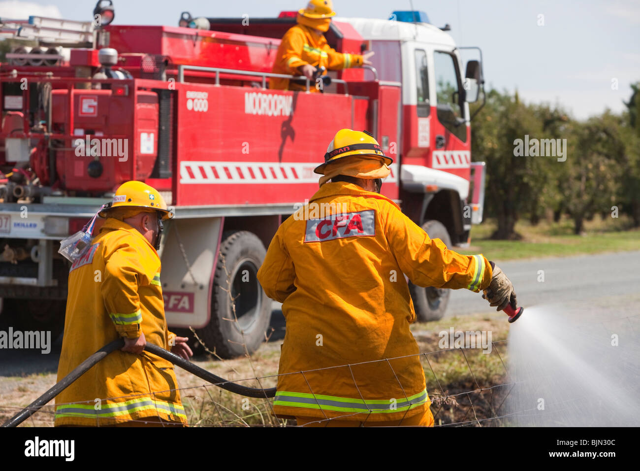 CFA fire fighters tackle a roadside fire near Shepperton, Victoria ...