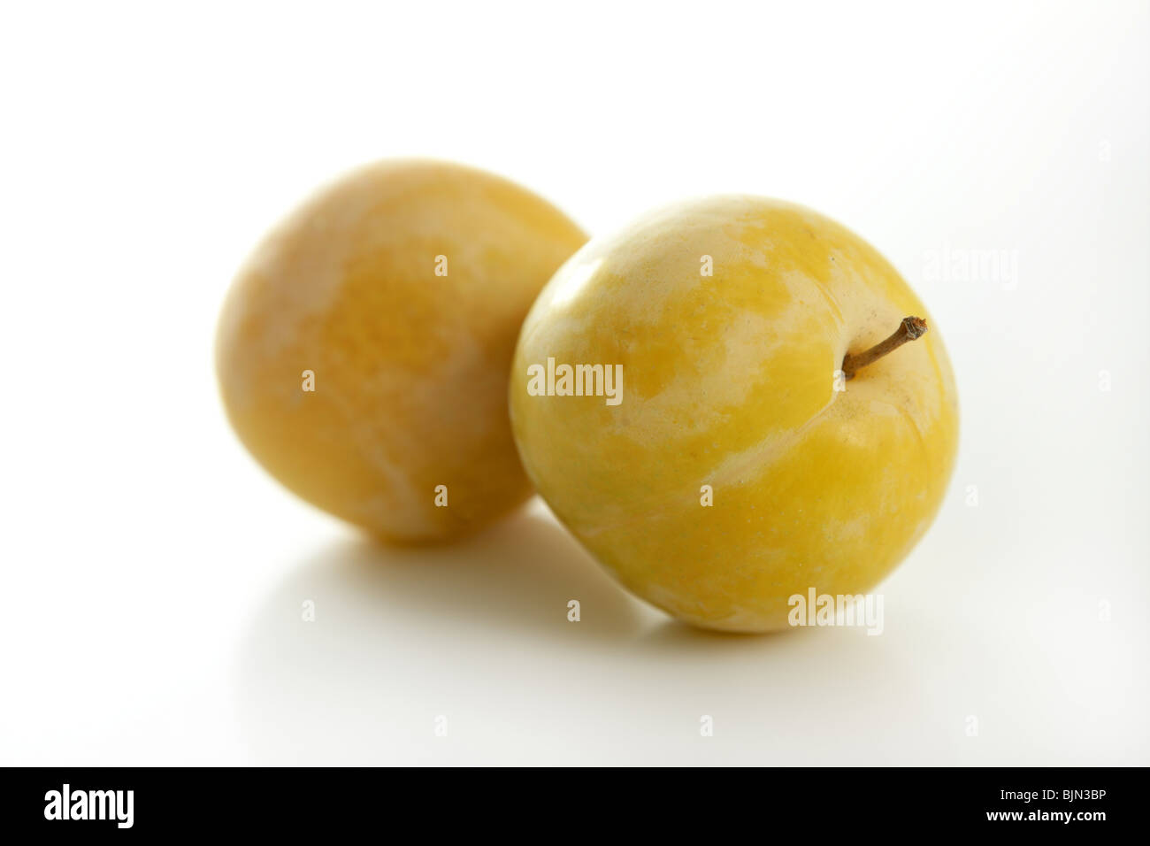 Close up of yellow Mirabelles on white studio background Stock Photo ...