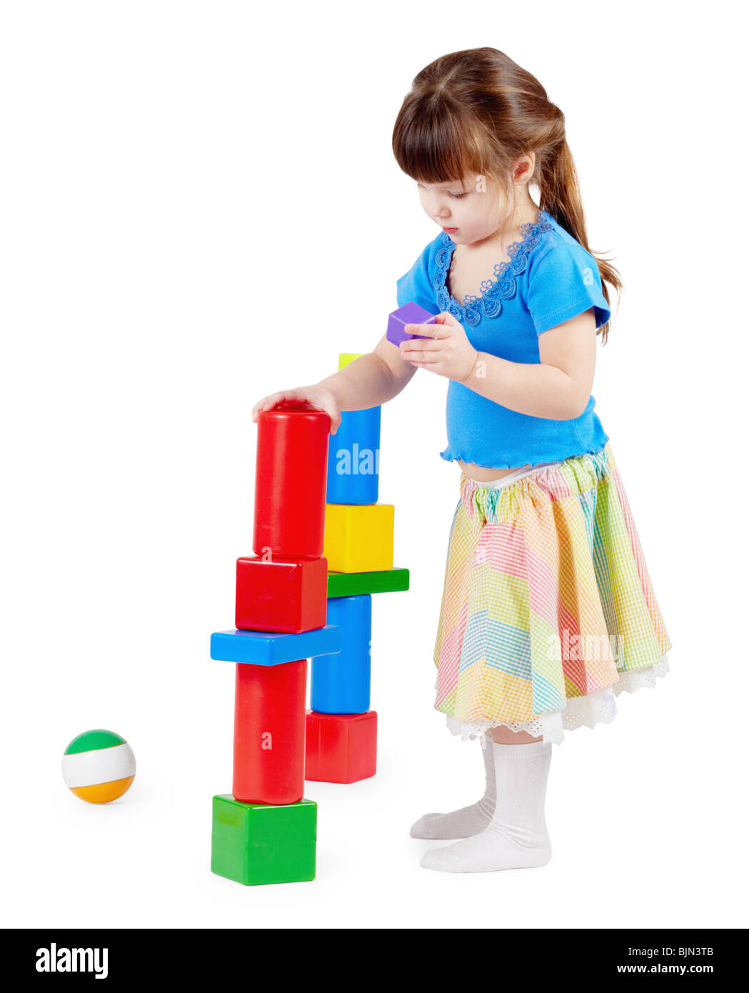 Girl build a tower of toy bricks on a white background Stock Photo - Alamy