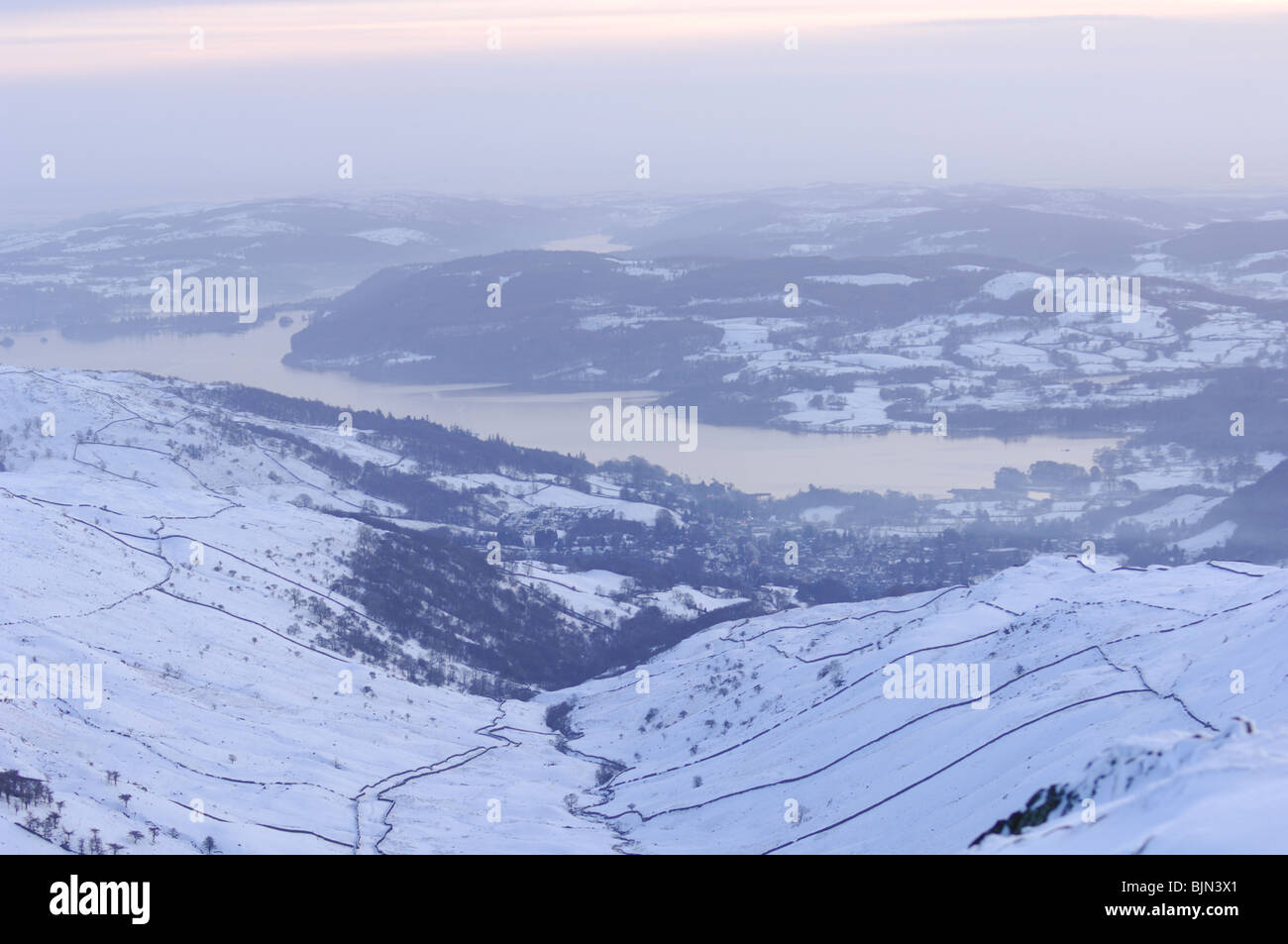 Snow covered Ambleside and Windermere under a cold evening sky Stock ...