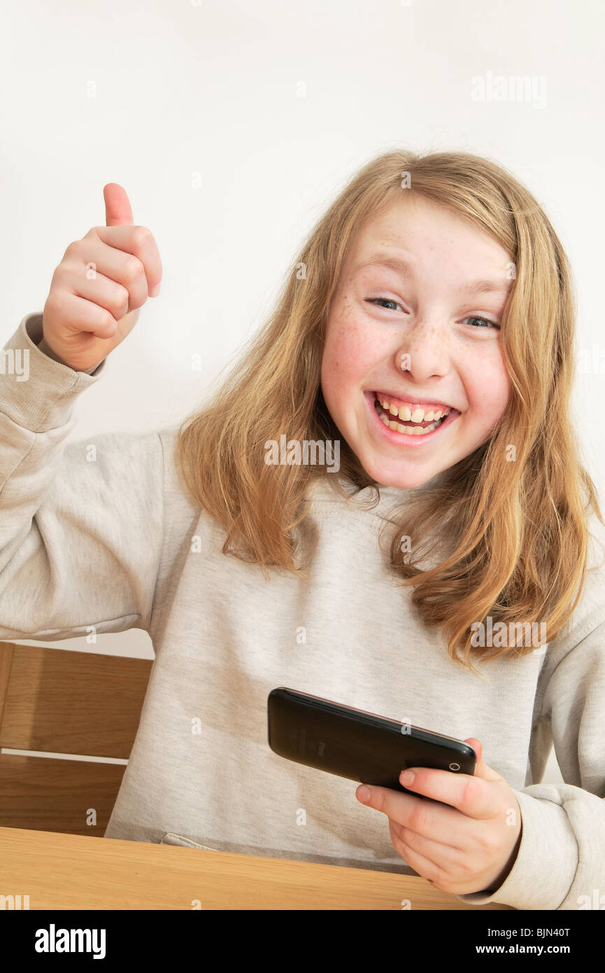 YOUNG GIRL PLAYING WITH AN IPHONE Stock Photo - Alamy