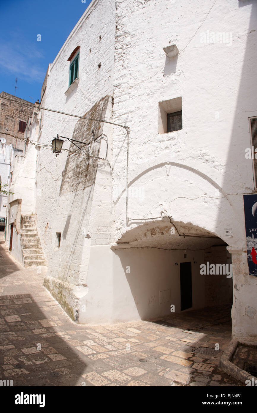The alleys and narrow streets of the white city of Ostuni, Puglia ...