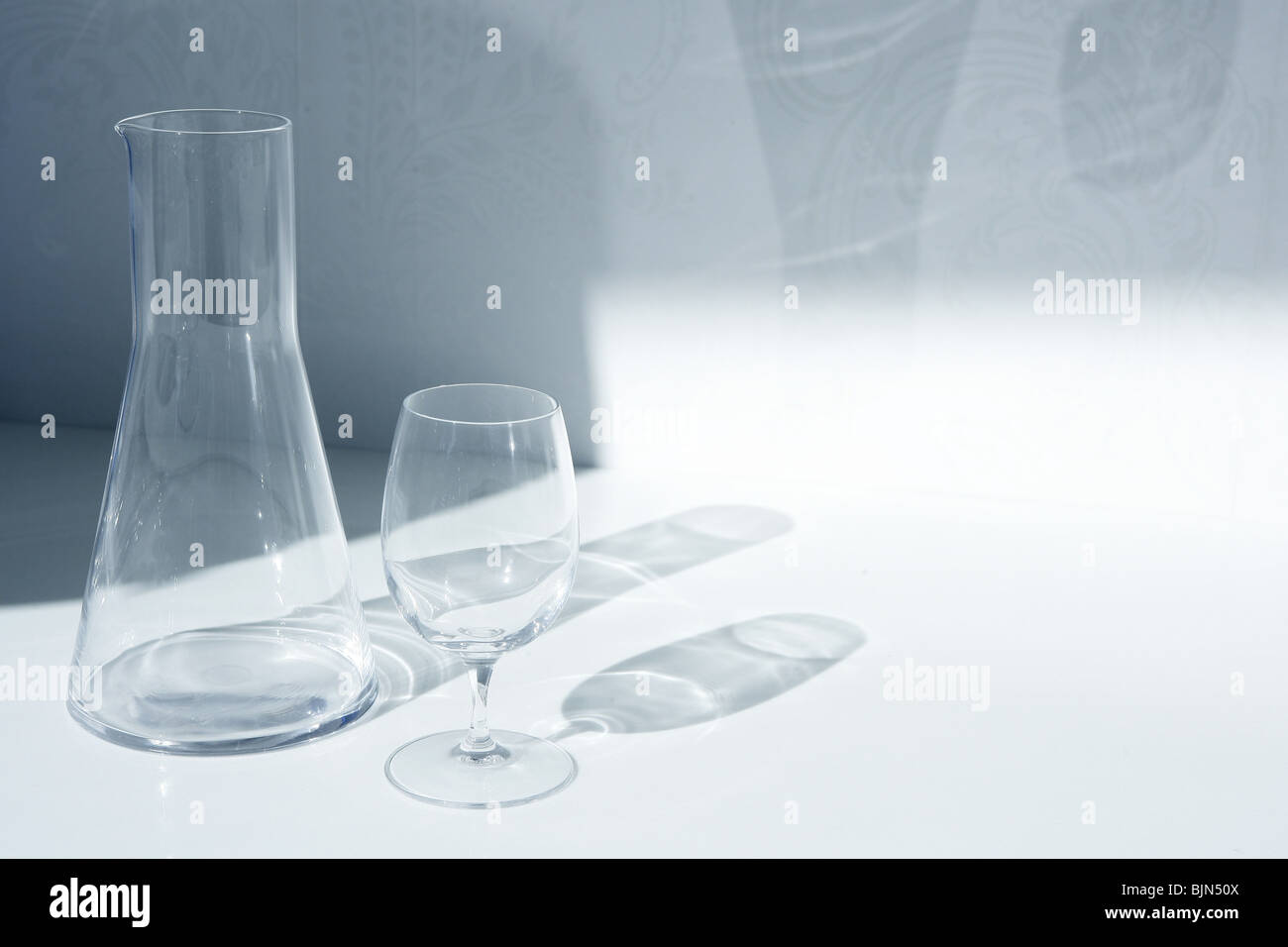Water glass and bottle with transparent shadows in white kitchen Stock ...