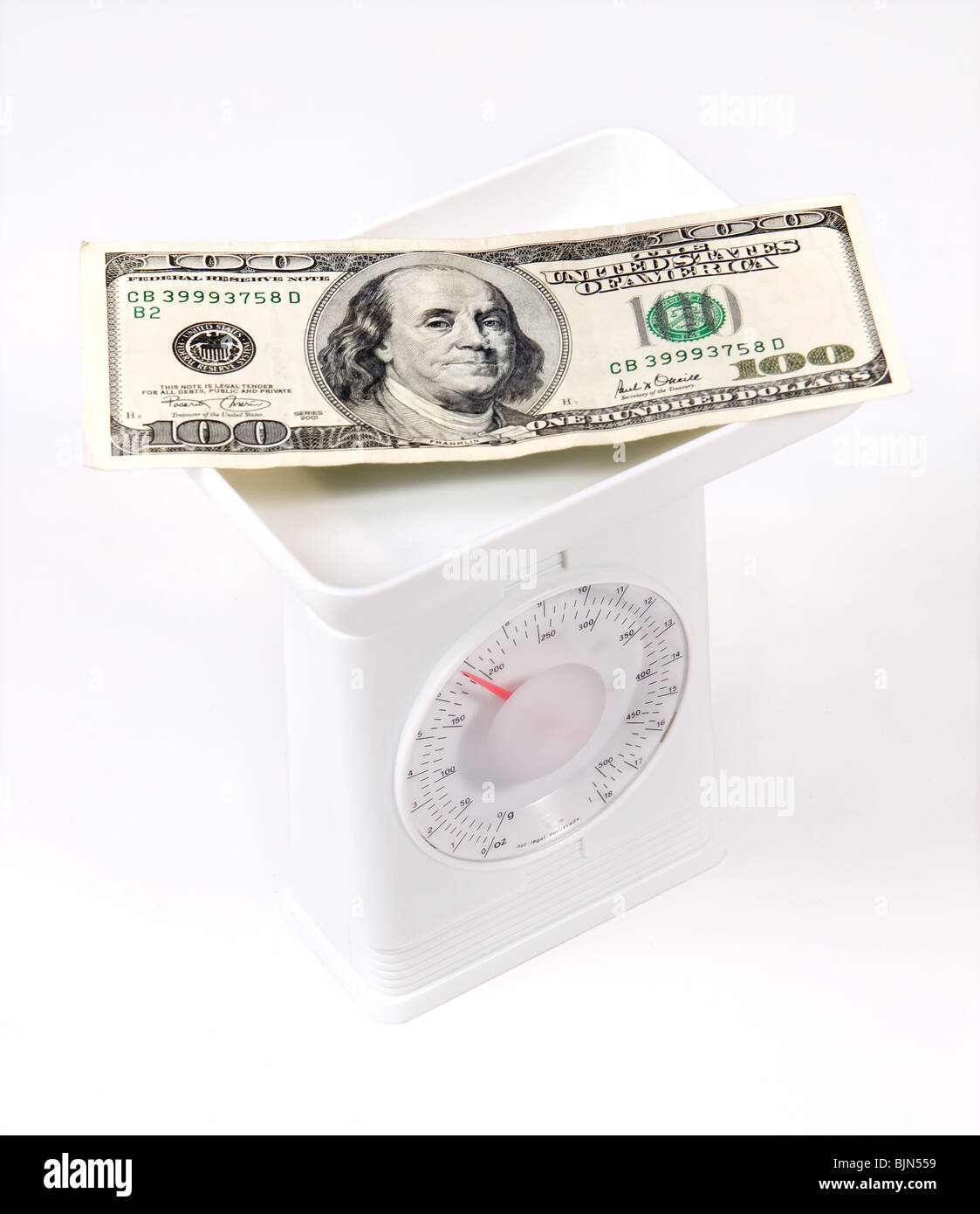 money on the kitchen weighing scale Stock Photo - Alamy