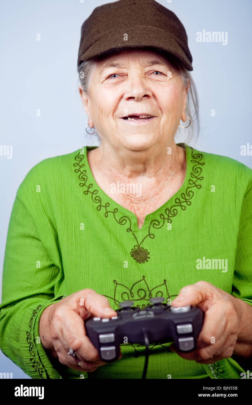 Senior woman playing video games hi-res stock photography and images ...