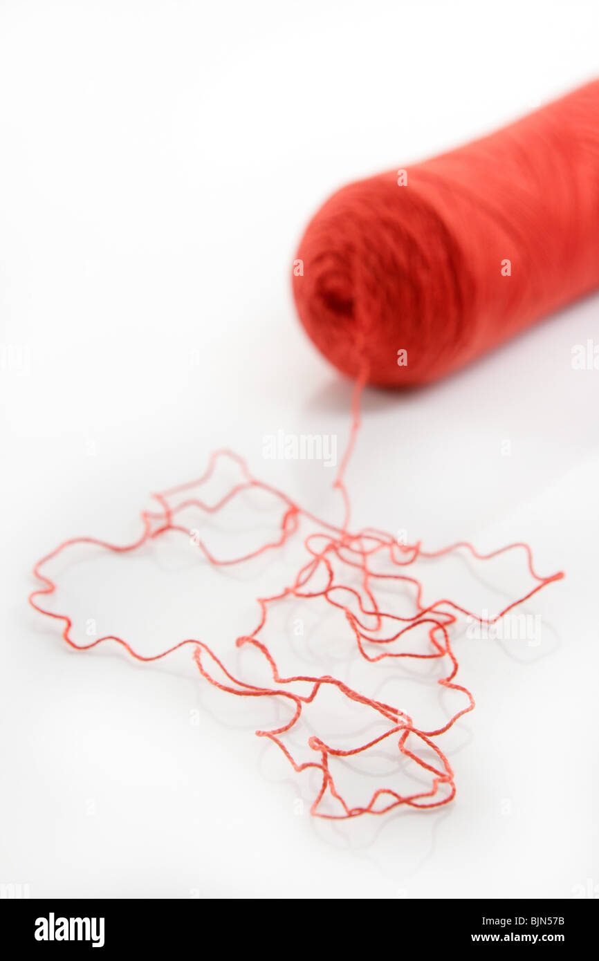 Red thread spool isolated over white studio background Stock Photo - Alamy