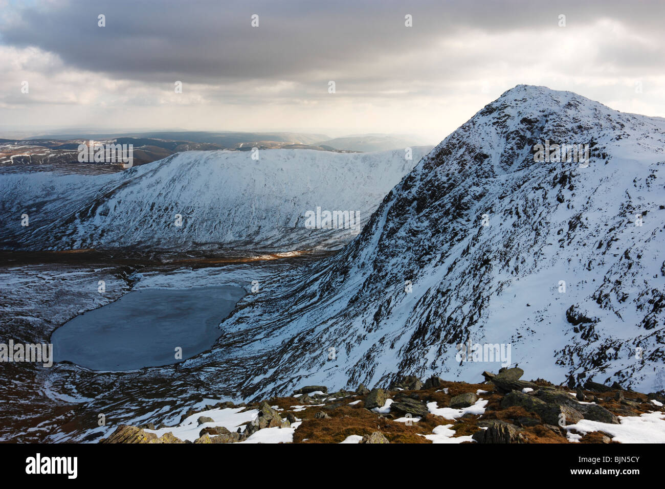 The summit of Aran Fawddwy overlooking the lake of Creiglyn Dyfi ...