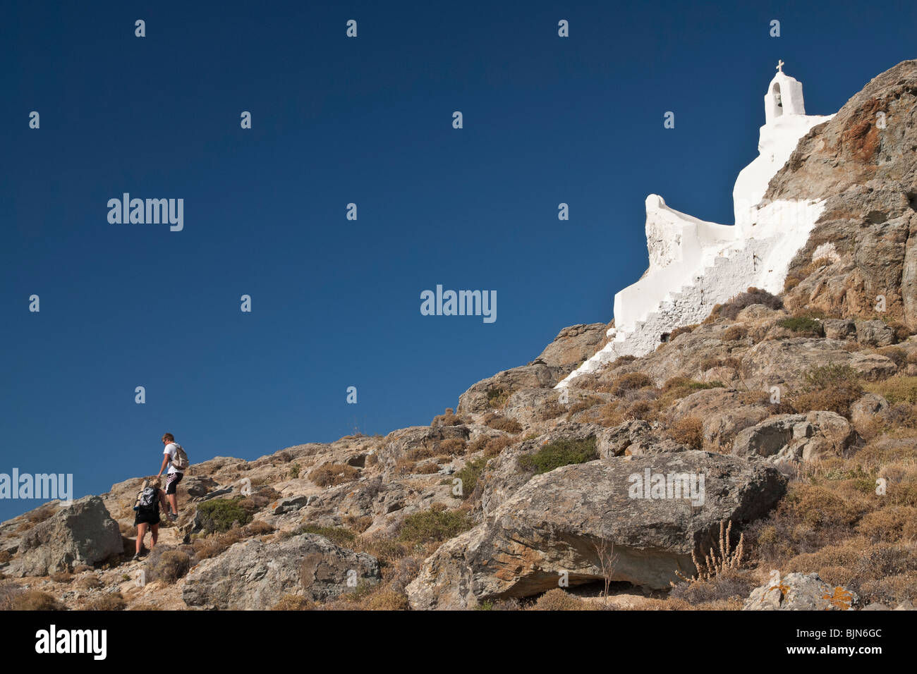 People walking up to a whitewashed church on Naxos Island, Greece Stock ...