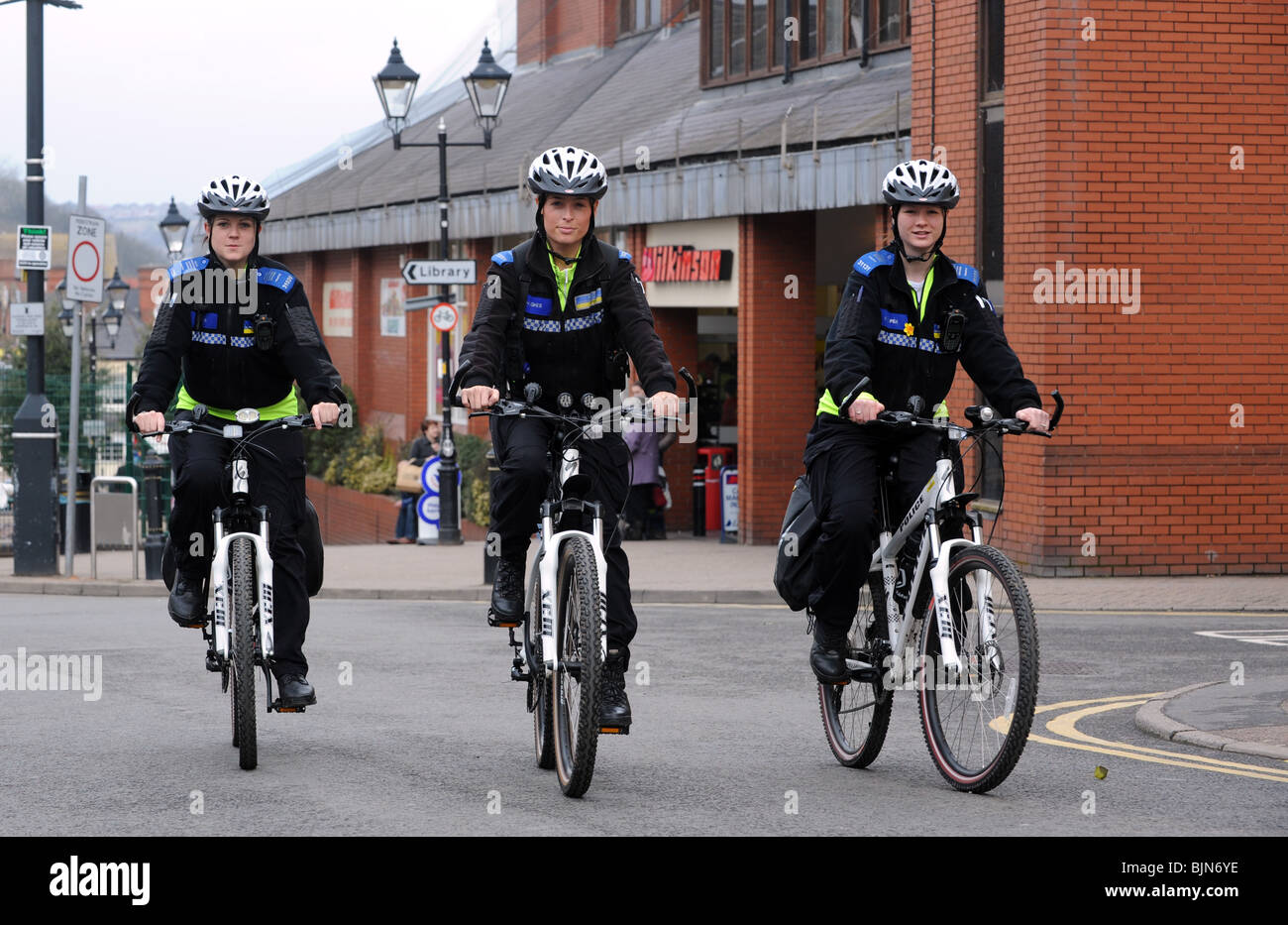 Three Police Community Support Officers patrolling on mountain bikes in ...