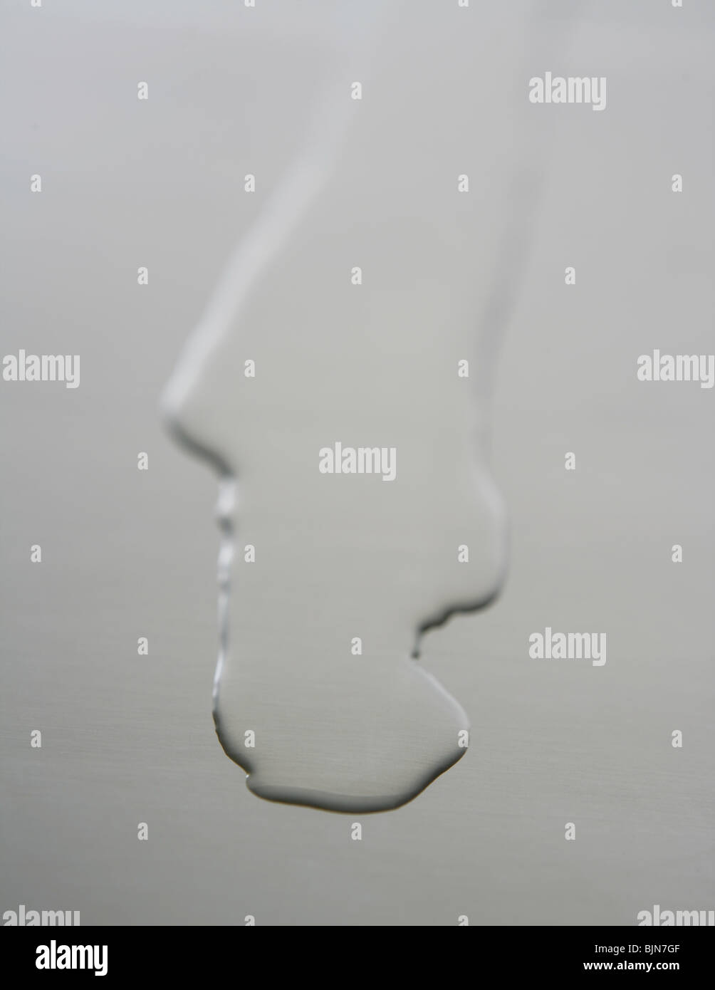 Liquid,transparent oil shape on a stainless steel metal surface Stock ...