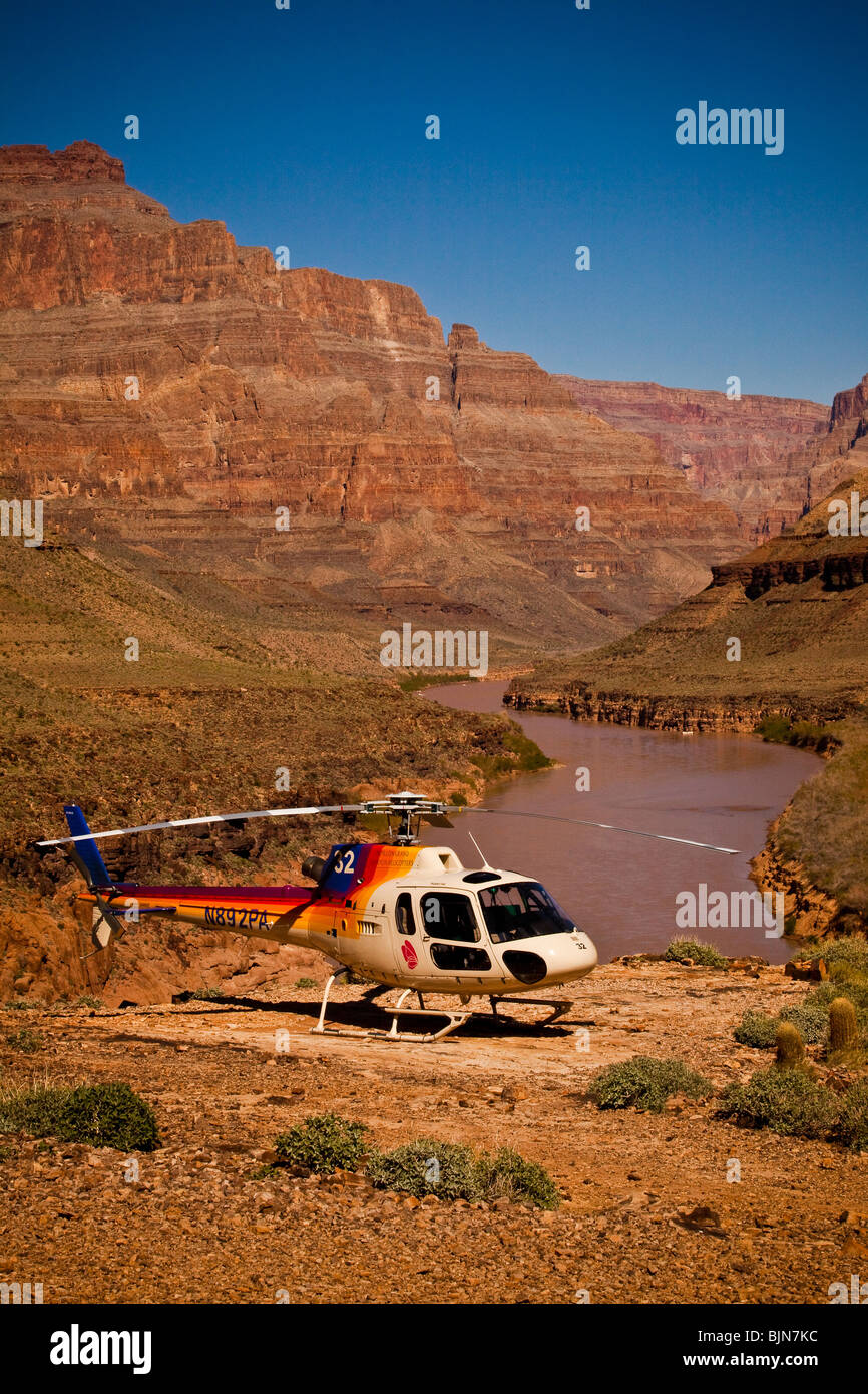 A helicopter at the Colorado river at the base of the Bridge Canyon ...