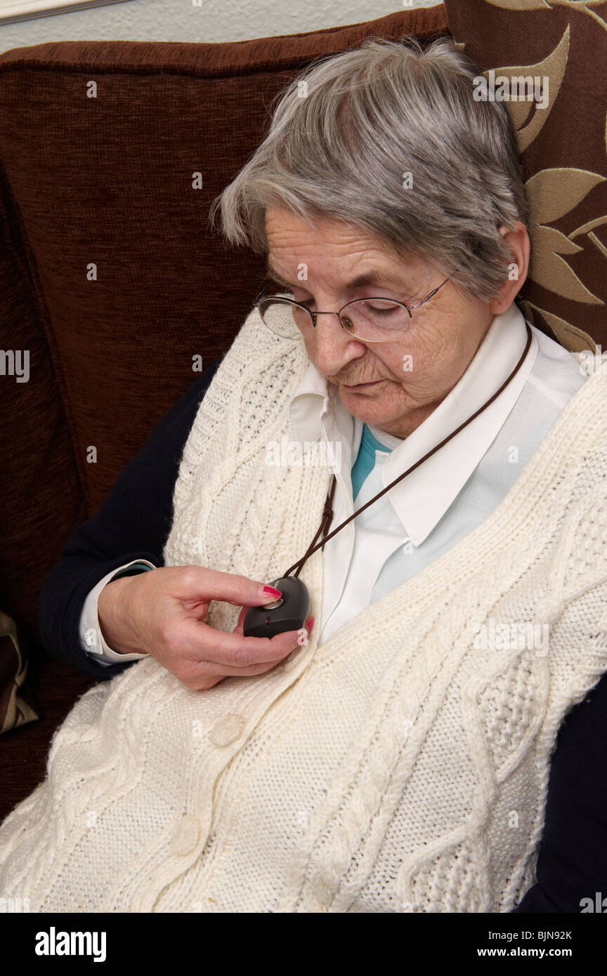Elderly lady with emergency alarm around neck Stock Photo - Alamy