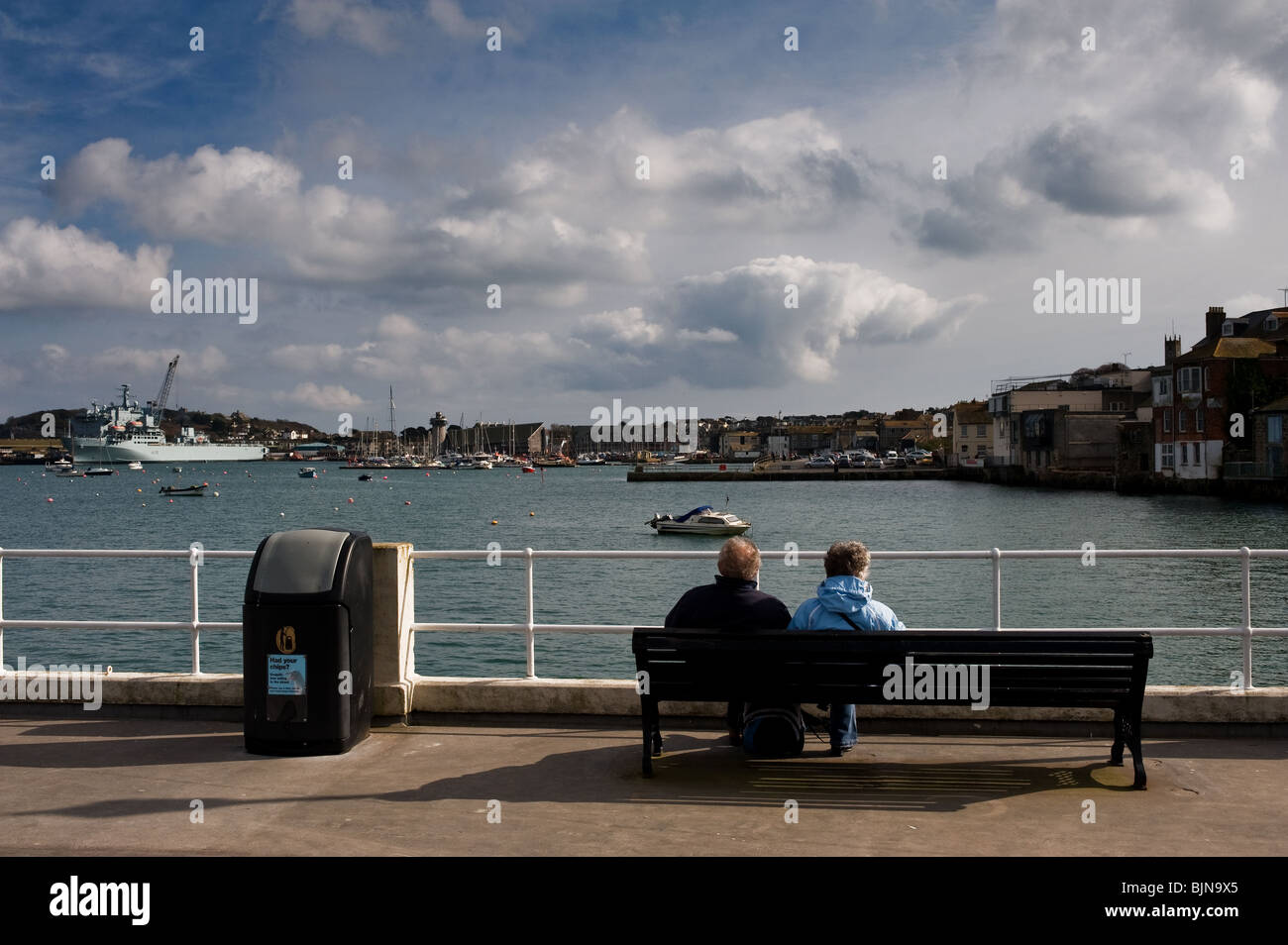 A couple sitting on a bench in Falmouth Harbour in Cornwall Stock Photo ...