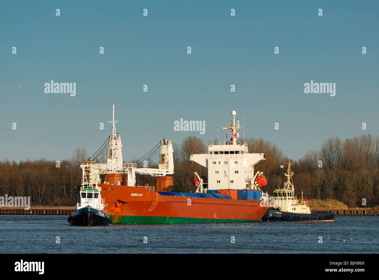 A huge red oil tanker and a tugboat at work Stock Photo - Alamy