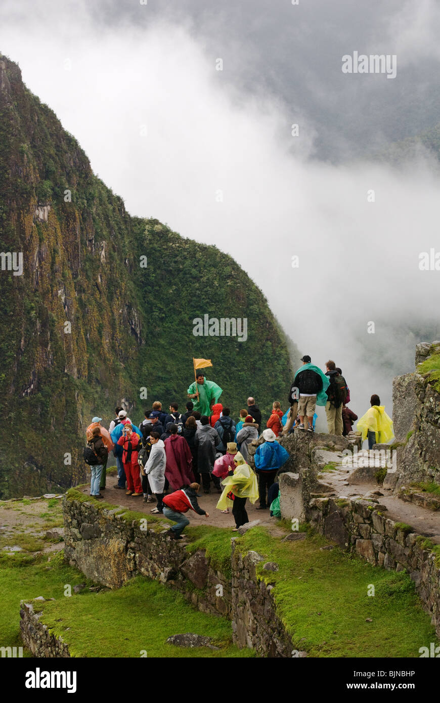 tourists in rain, machu picchu Stock Photo - Alamy