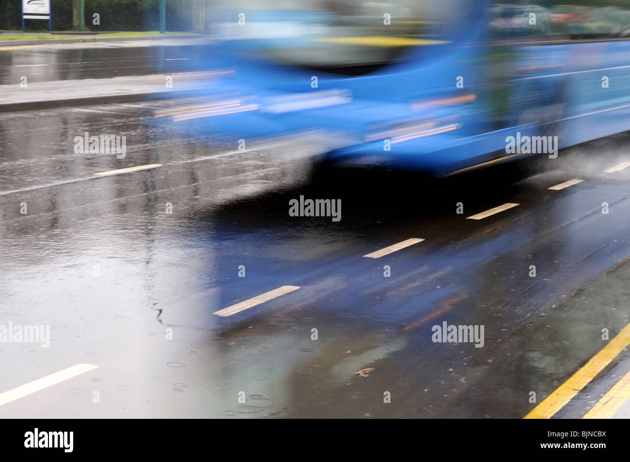 Bus on Wet Road Surface Stock Photo - Alamy