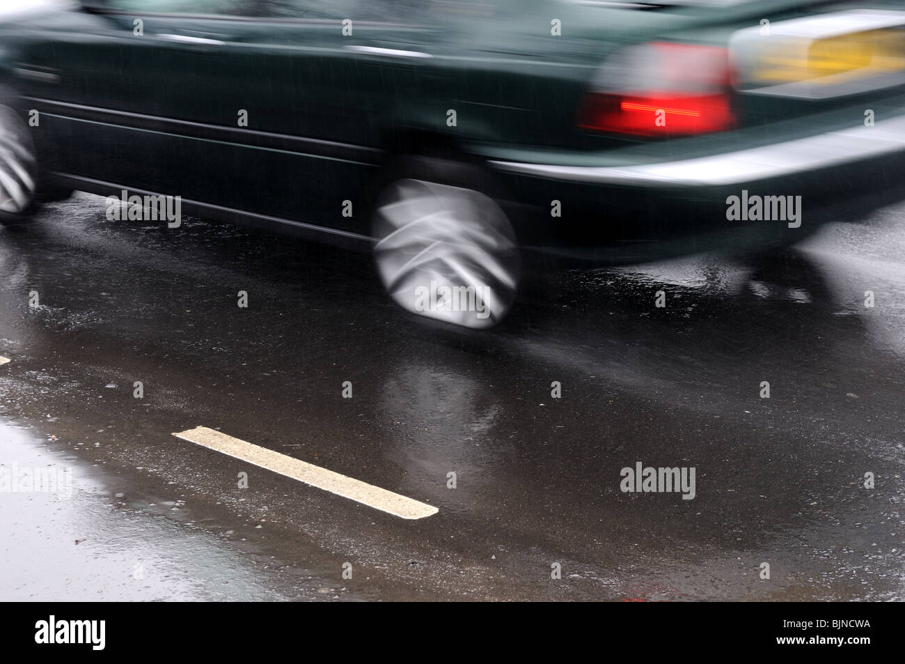 Car on Wet Road Surface Stock Photo - Alamy